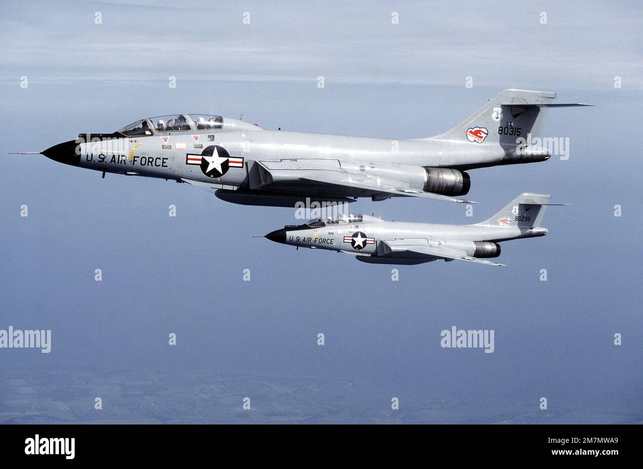 AN air-to-air left side view of two F-101 Voodoo aircraft in flight ...