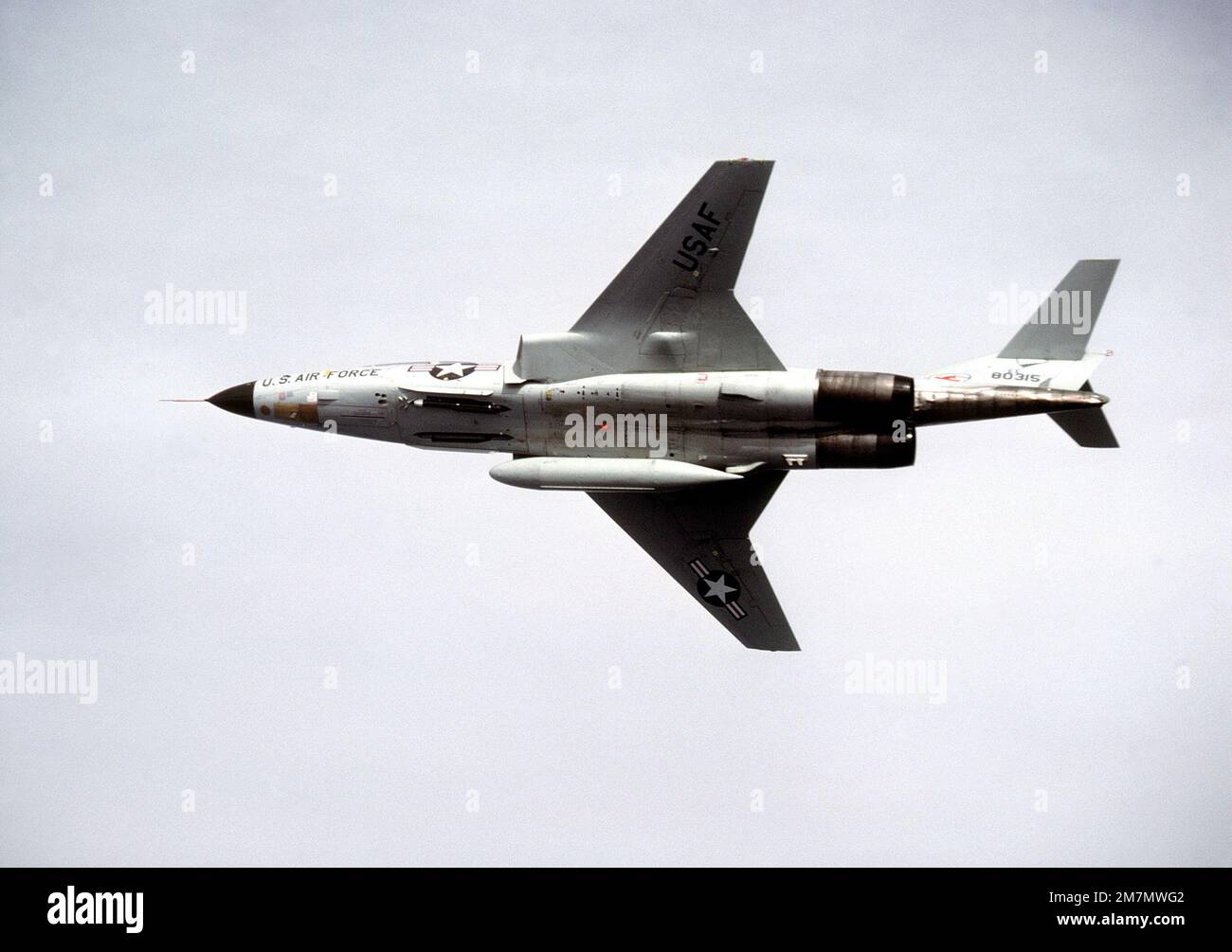 A air-to-air underside view of an F-101 Voodoo aircraft banking to the ...