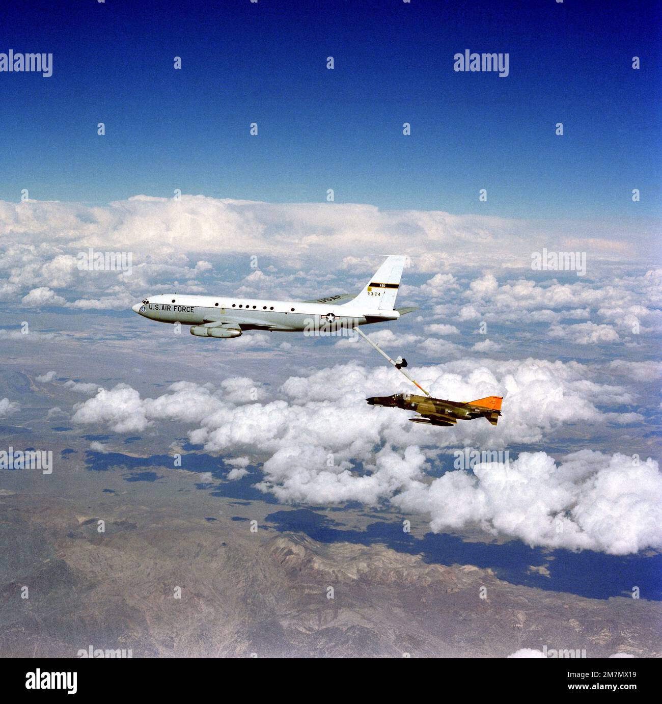 An air-to-air left side view of an F-4 Phantom II aircraft being ...