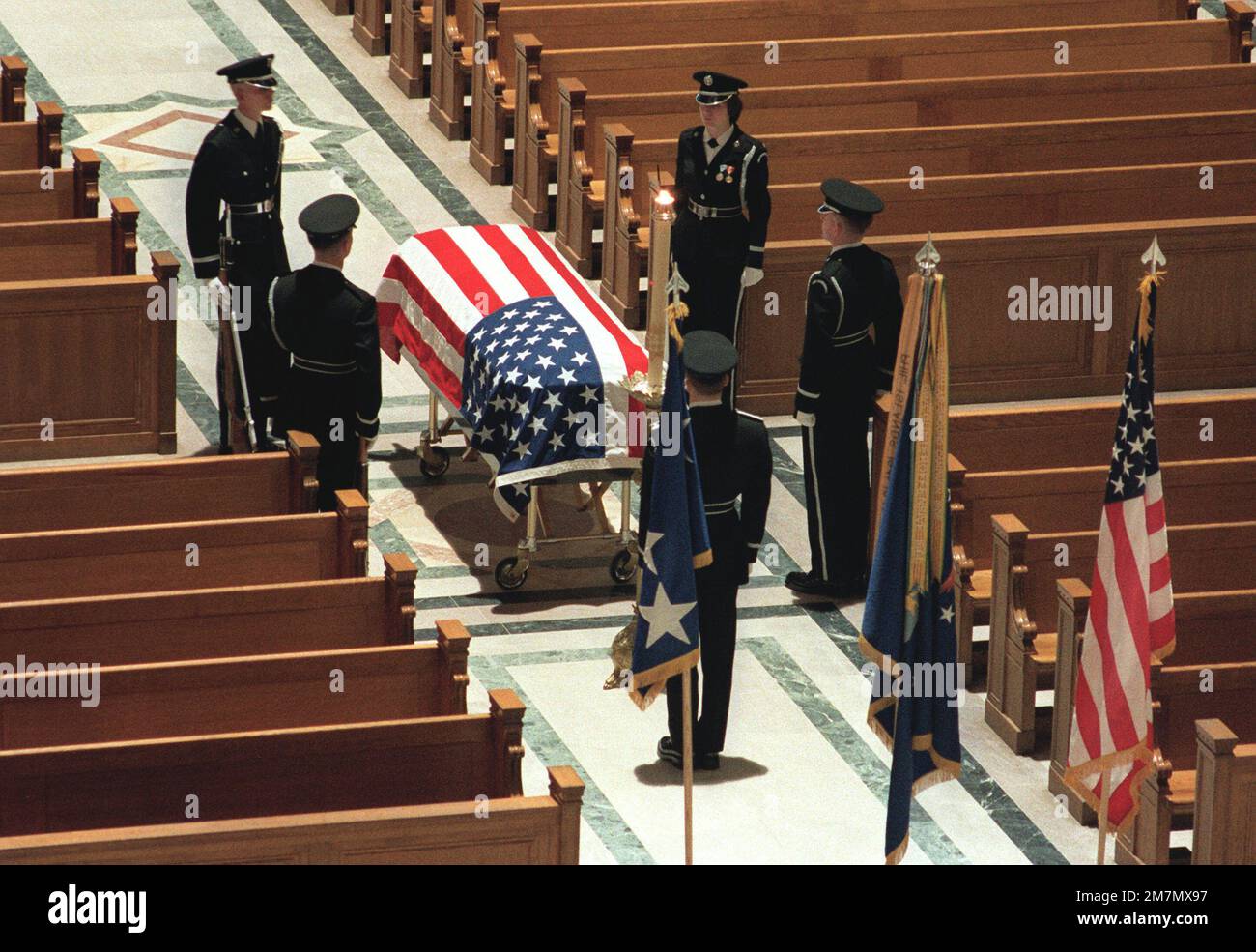 Honor Guard pallbearers watch over the casket on an aisle during the ...