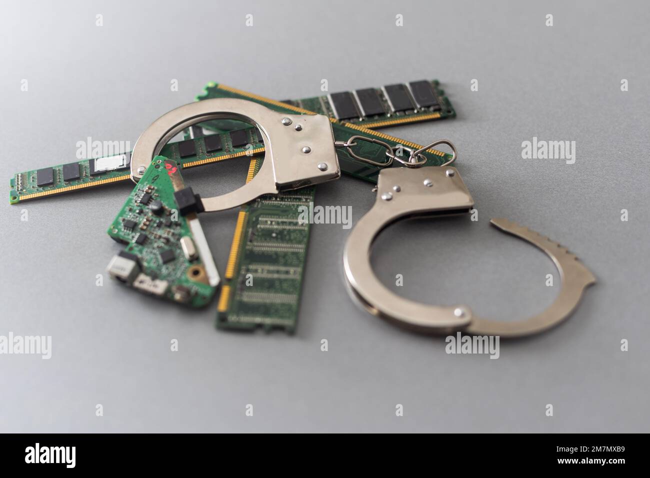 Digital security concept: handcuffs on the background of a computer ...