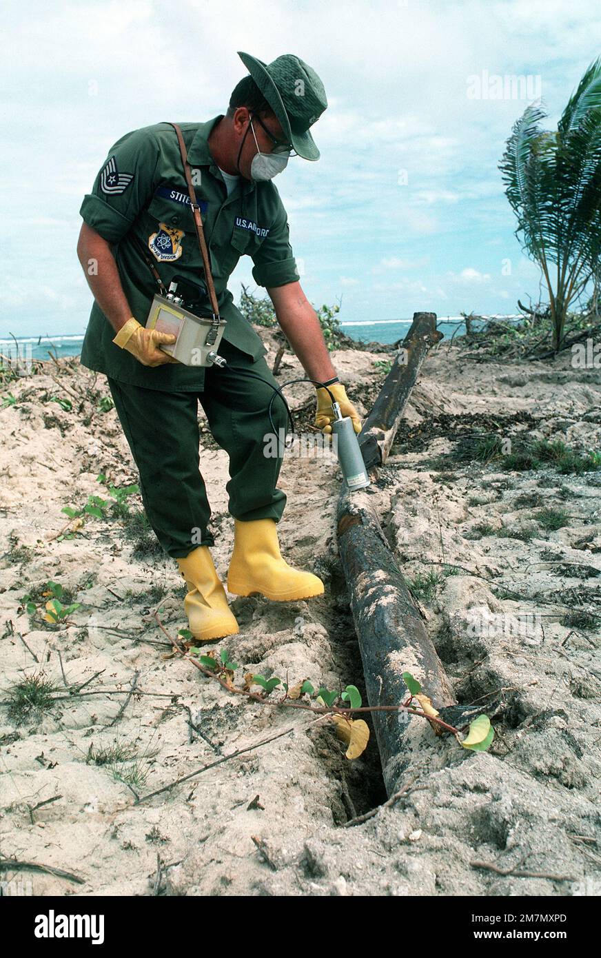 An Air Force TECH. SGT. checks for radiation on the island of Runit ...