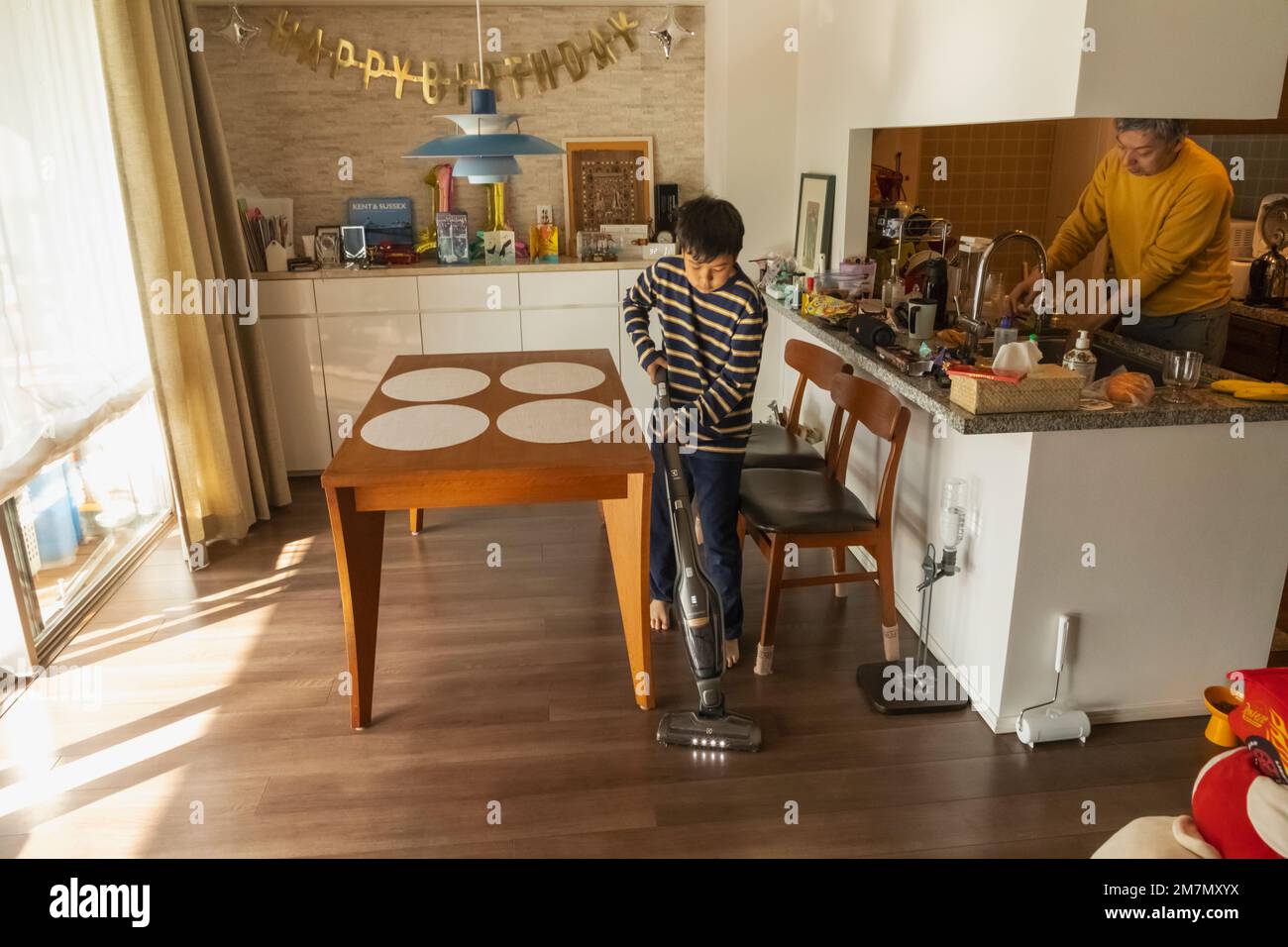Japan, Honshu, Tokyo, Young Japanese Boy and Father Doing Housework in ...