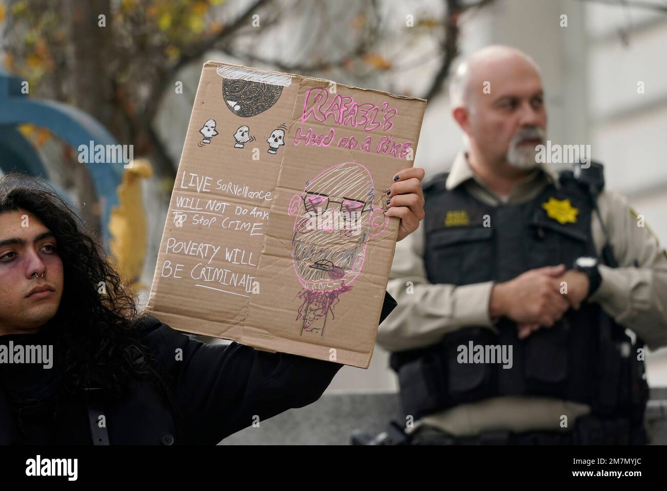 A protester holds up a sign while taking part in a demonstration about ...