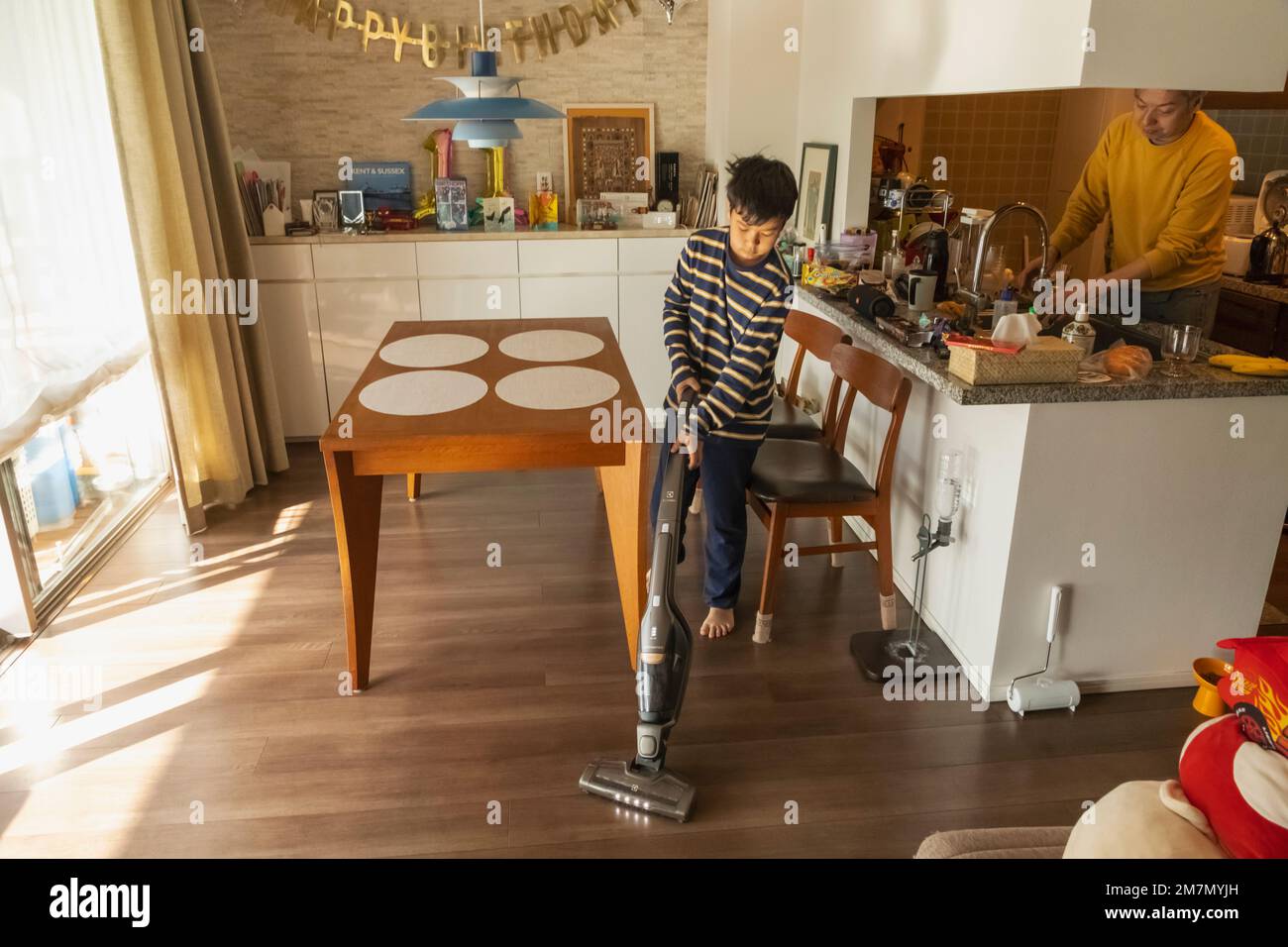 Japan, Honshu, Tokyo, Young Japanese Boy and Father Doing Housework in ...