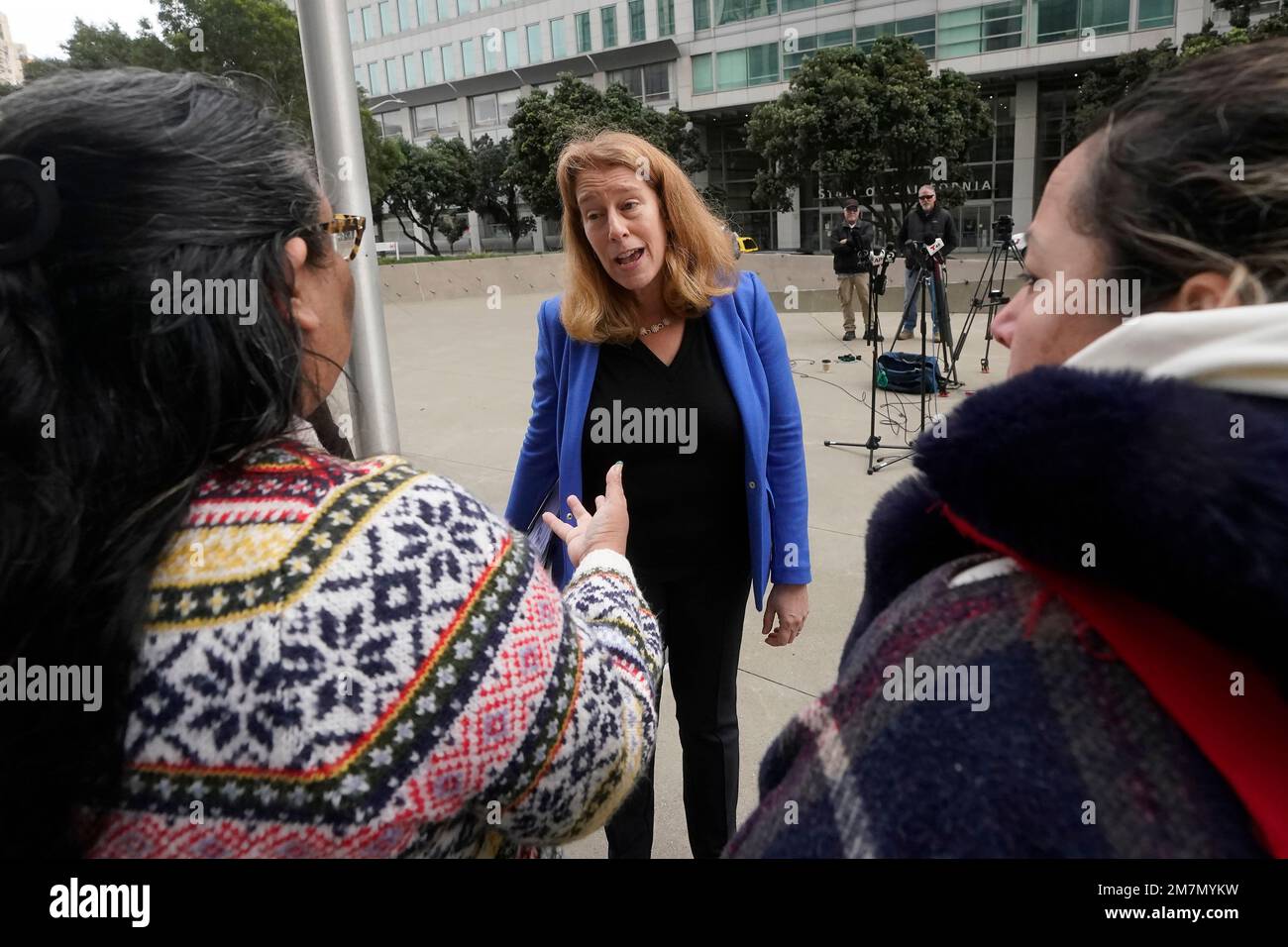 Attorney Shannon Liss-Riordan, middle, speaks with former janitors at ...