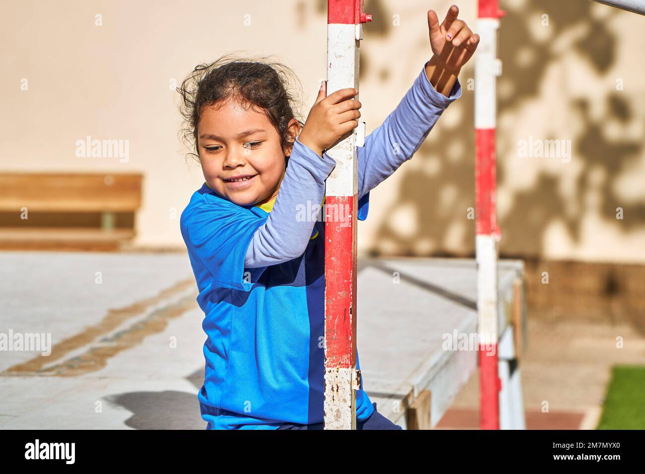 happy latin girl football player in a sport suit playing on a soccer ...