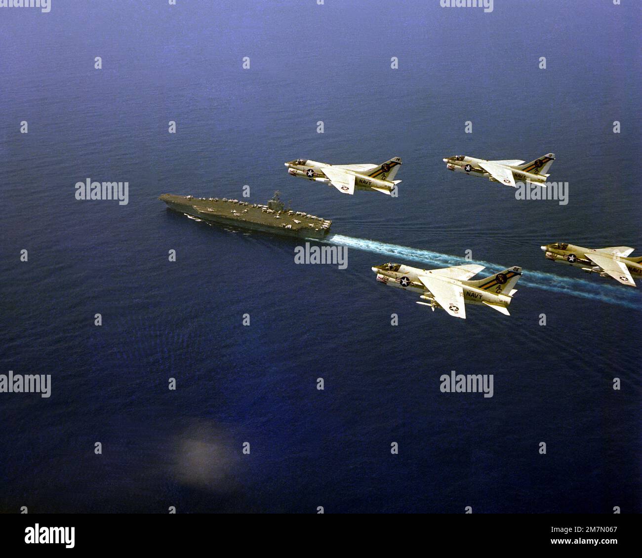 An air-to-air left side view of four Attack Squadron 66 (VA-66) A-7E ...