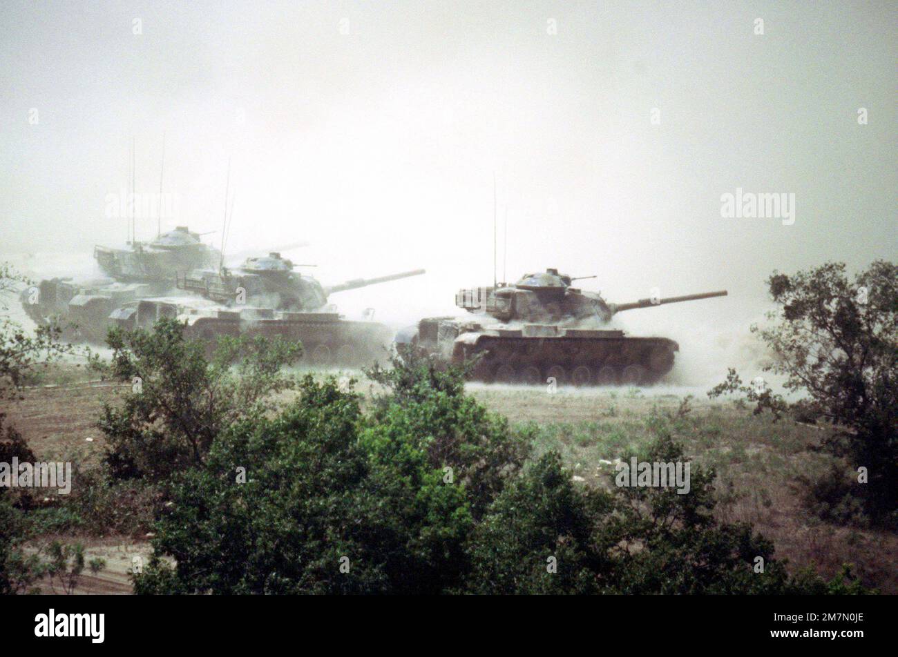 M-60A1 main battle tanks maneuver on the firing range during a mock ...