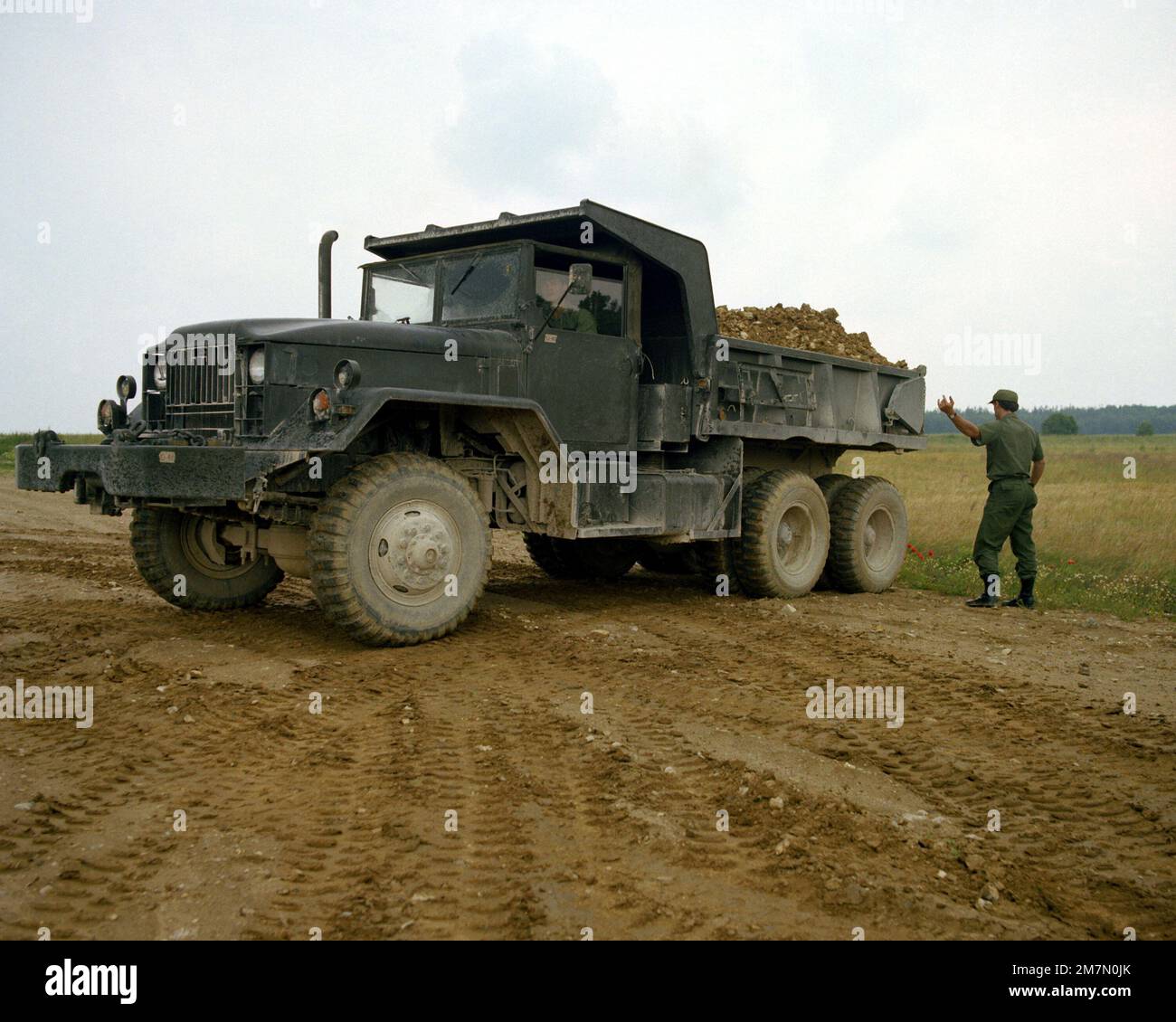 Members of the 1457th Engineering Battalion haul truckloads of dirt ...