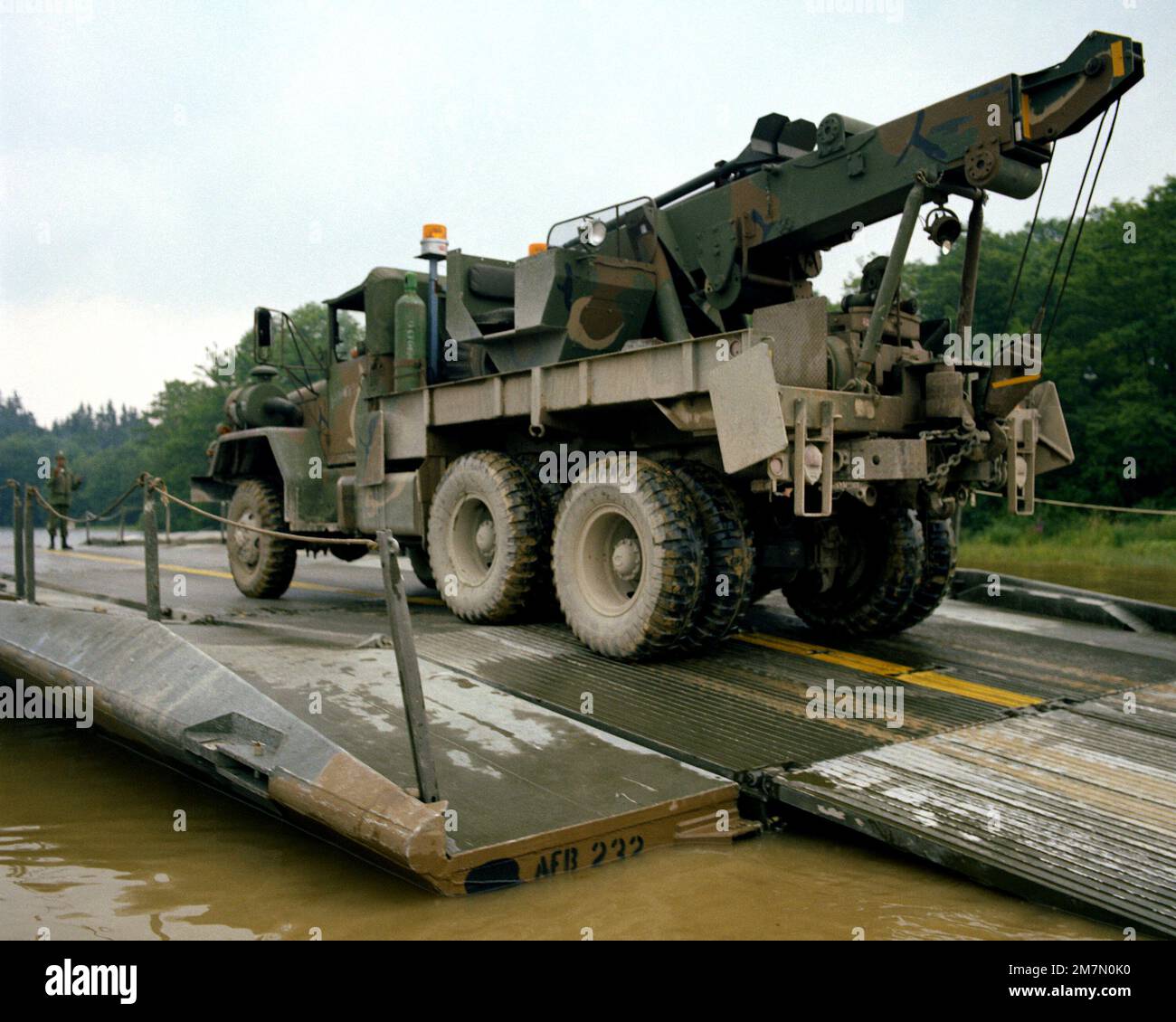 A 5-ton truck is driven across a ribbon bridge constructed by members ...