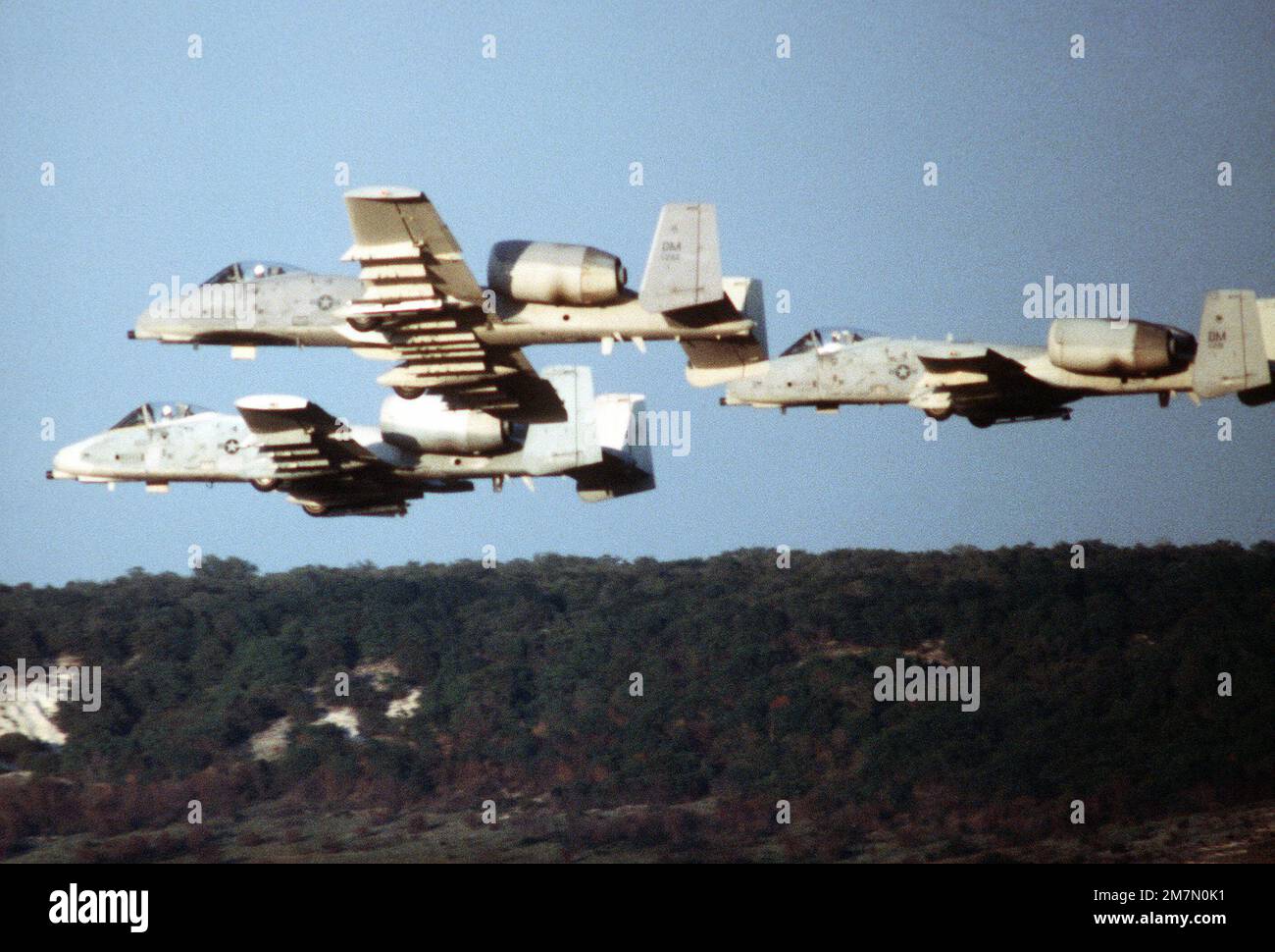 A ground-to-air left side view of three A-10A Thunderbolt II aircraft ...