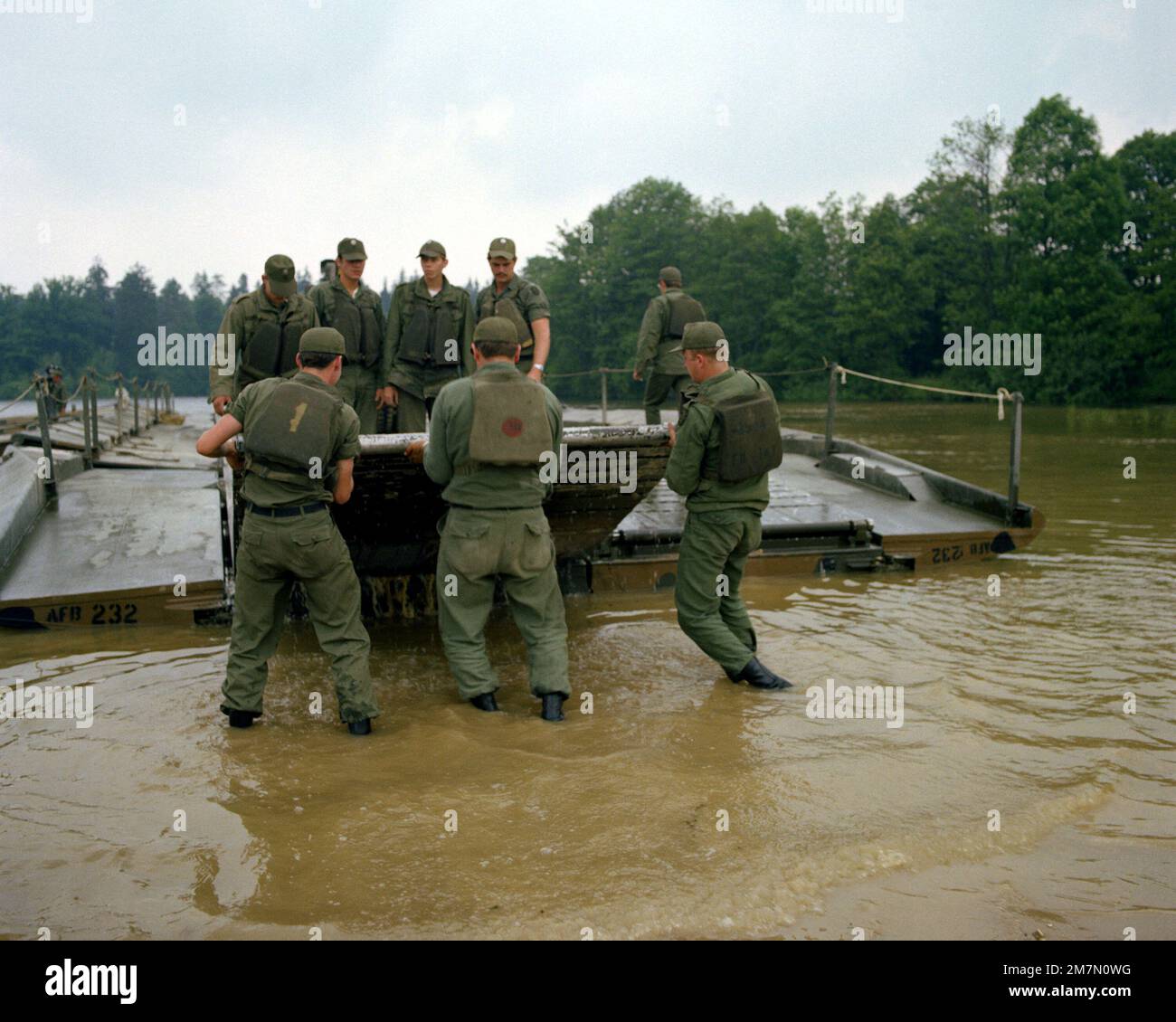 A ribbon bridge is assembled by members of the 1457th Engineering ...