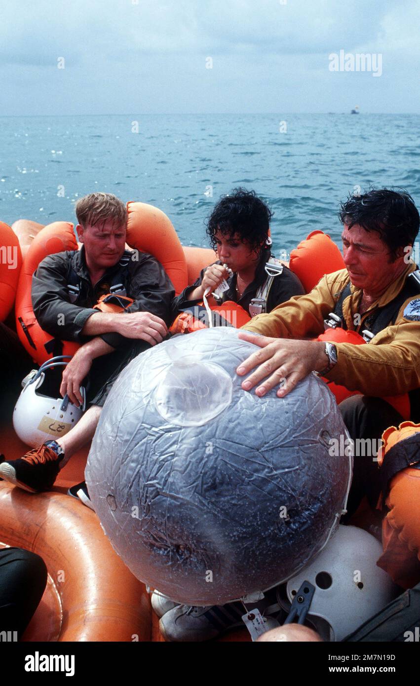 Astronaut Judy Resnick inflates a solar water still during20-man life ...