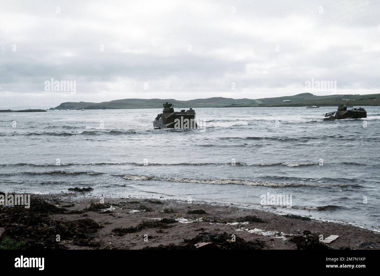 Two personnel tracked landing vehicles (LVTP-7) prepare to come ashore ...
