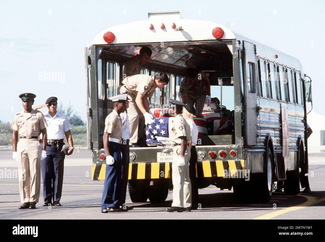 Combined services pallbearers place the flag draped casket of a former ...