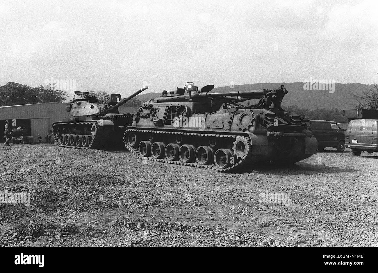 A right side view of an M-88 armored recovery vehicle front and an M-60 ...