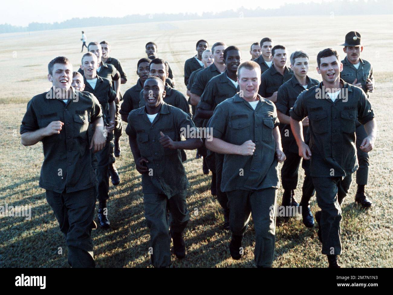 Soldiers double time across an open field during physical training ...