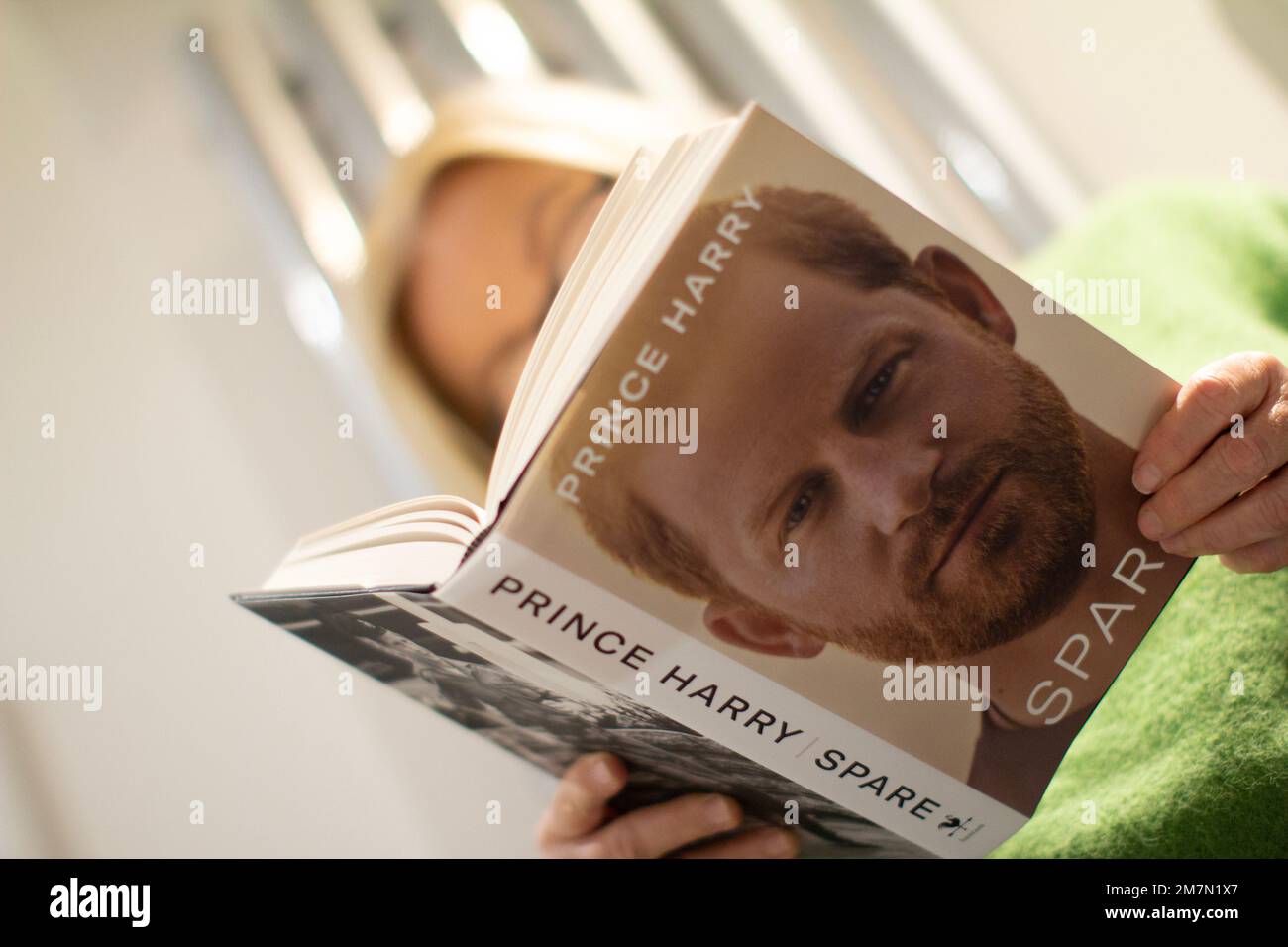 Female reading Prince Harry Spare memoir , autobiography book, in ...