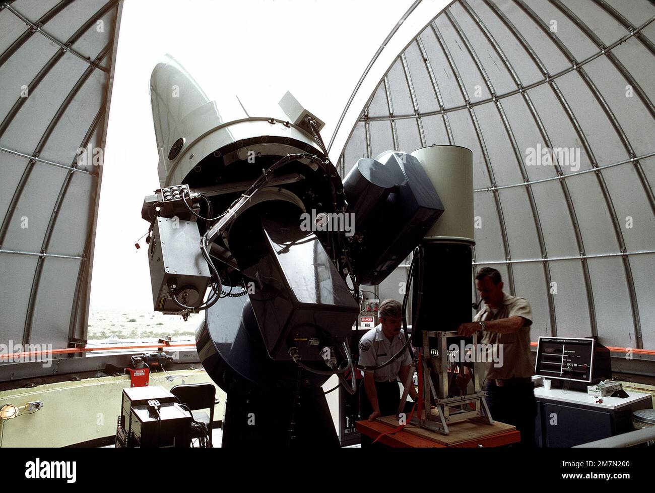 A technician and a staff sergeant attach a device which will connect ...