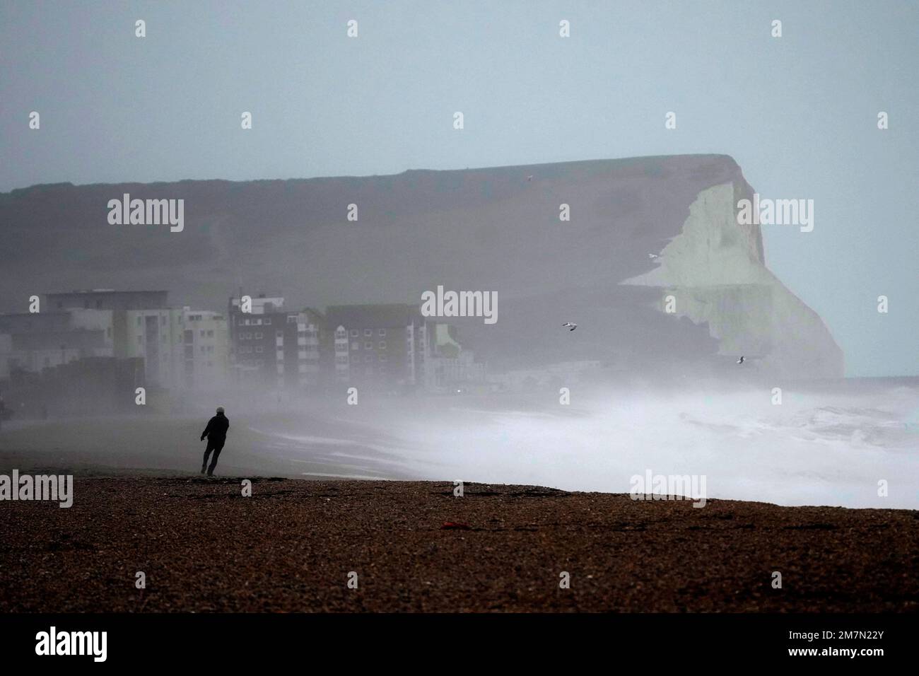 A person walks on Seaford Beach, as Storm Eunice hits Seaford and the ...