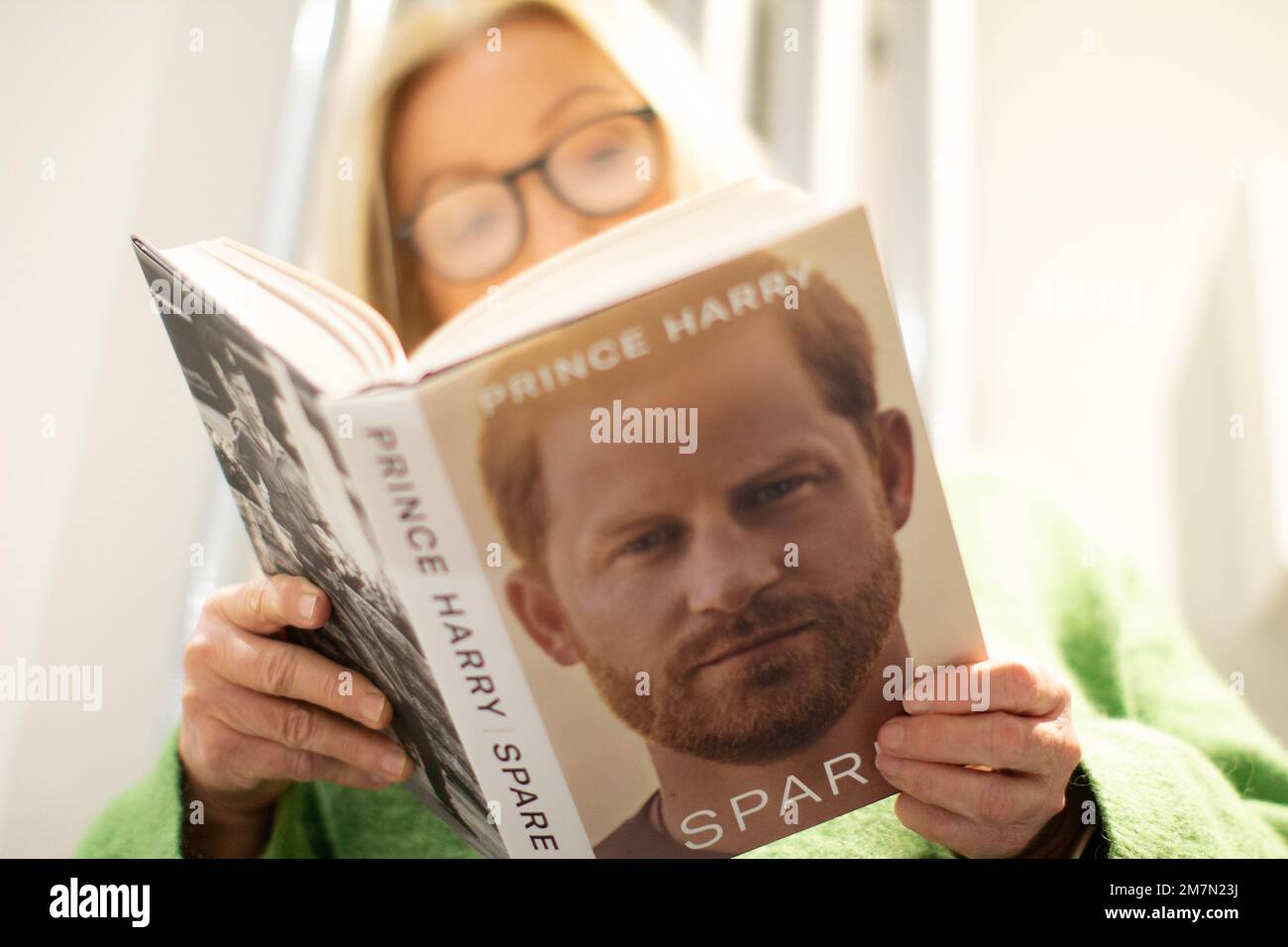 Female reading Prince Harry Spare memoir , autobiography book, in ...