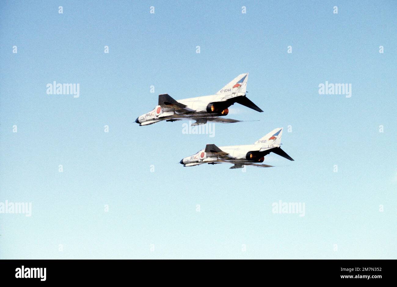 A ground-to-air left rear view of two Mitsubishi-built F-4EJ Phantom II ...