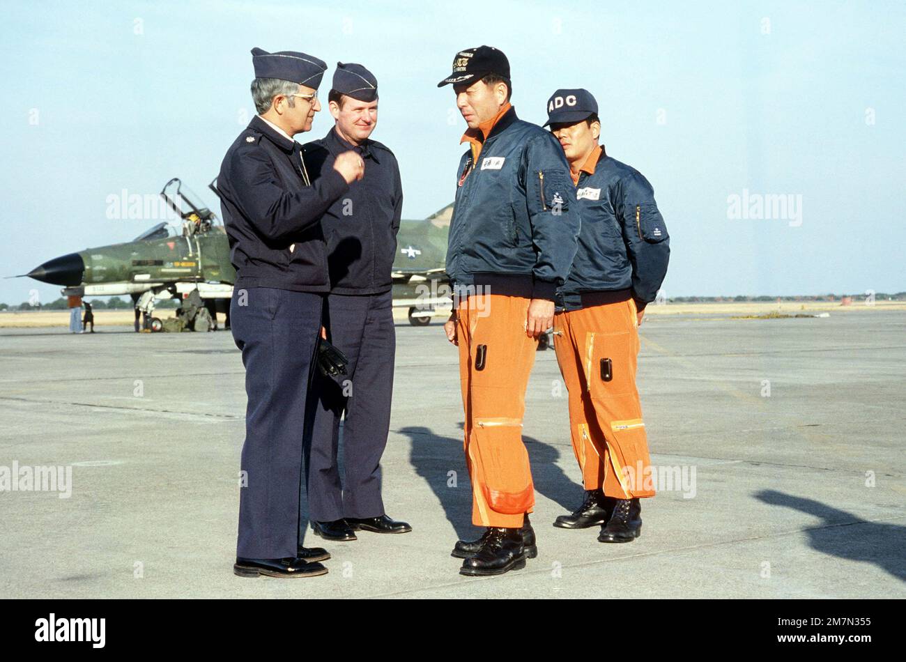 Japanese pilots and US Air Force officers discuss operations on the ...