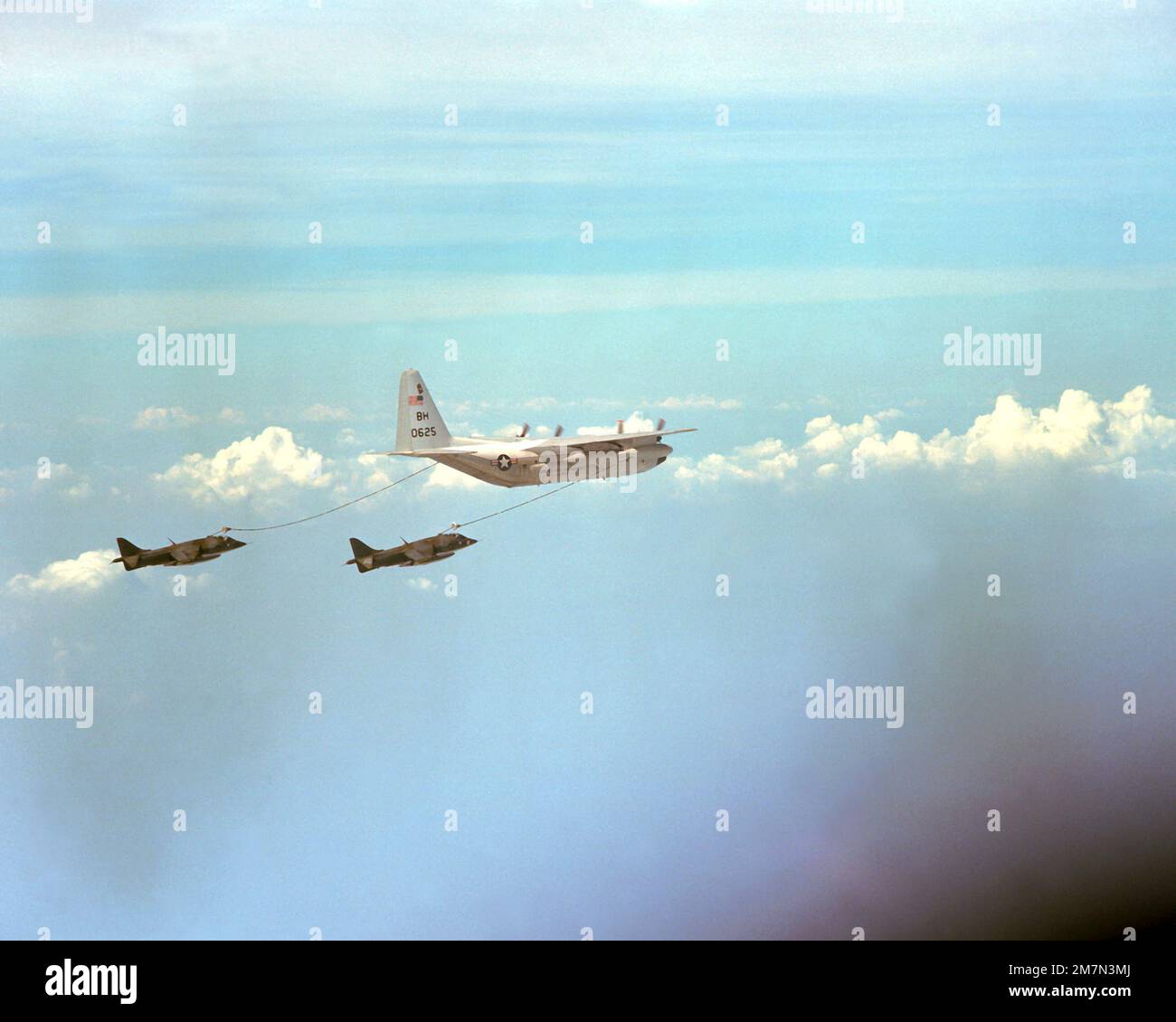 Two Marine Corps AV-8A Harrier aircraft receive fuel from a Marine ...