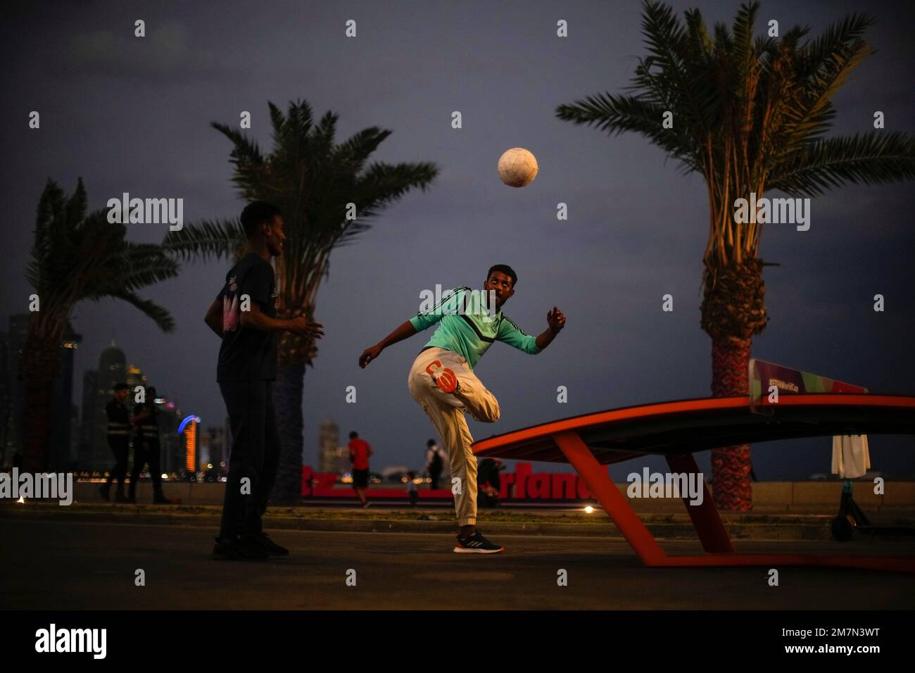 Men play a ball at the Corniche sea promenade in Doha, Qatar, Wednesday ...