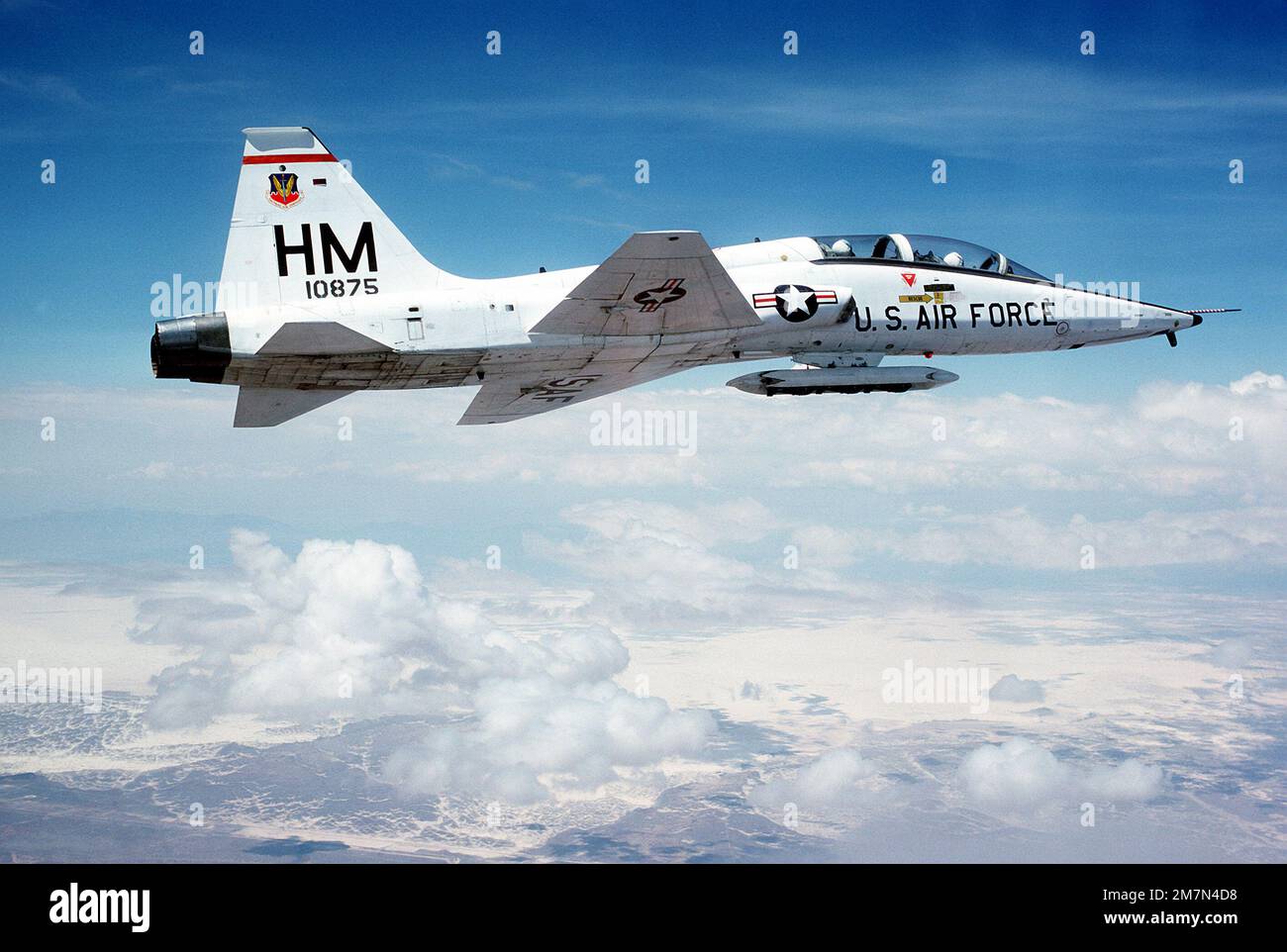 An air-to-air right side view of a T-38 Talon aircraft. The aircraft is ...