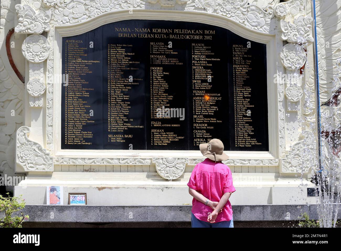 A foreign tourist looks at the plaque bearing names of the victims of ...