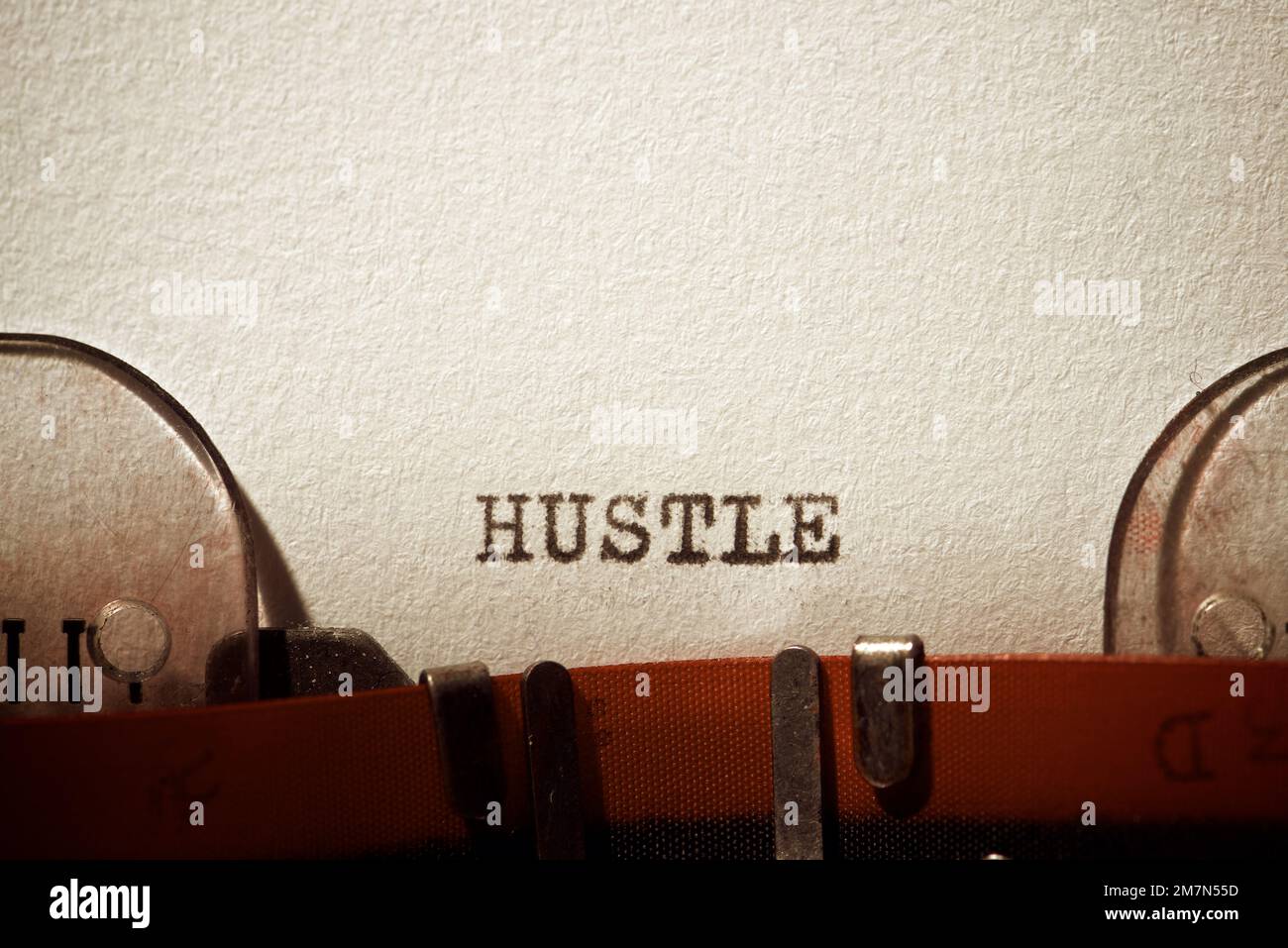 Hustle word written with a typewriter Stock Photo - Alamy