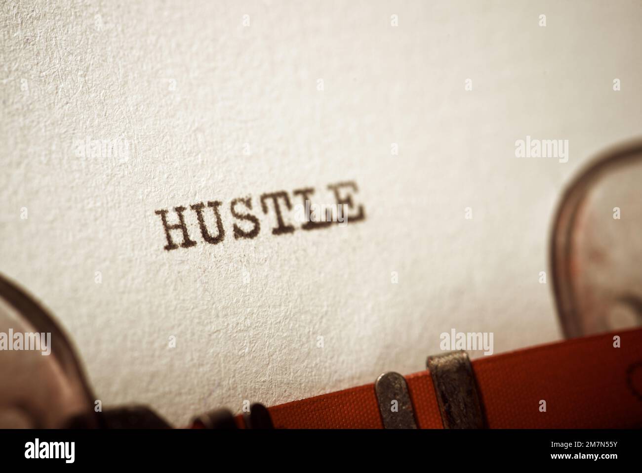 Hustle word written with a typewriter Stock Photo - Alamy