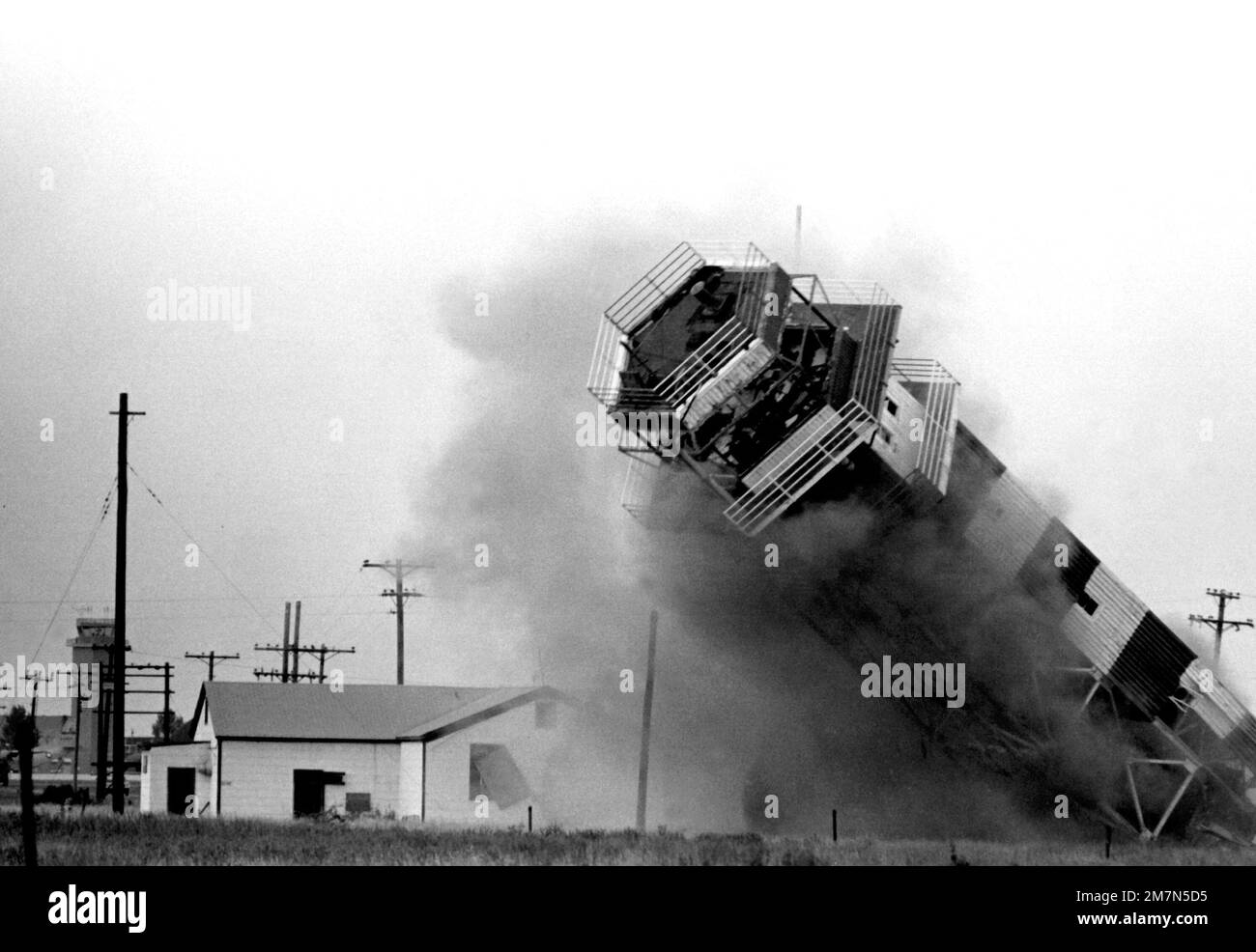 An old air control tower, replaced in 1978 by a new tower, falls after ...