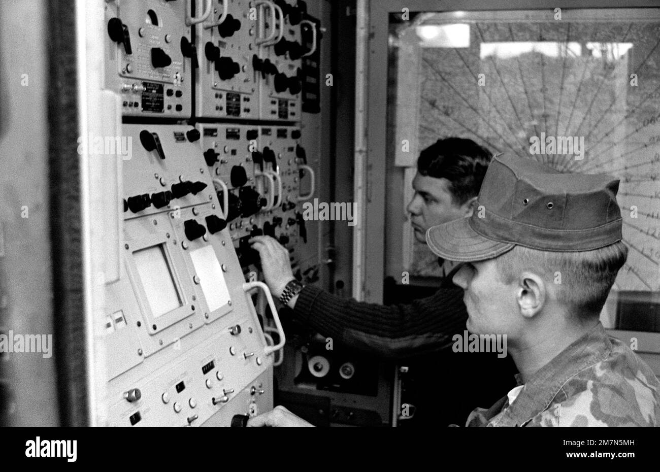 Two Marines operate the air support radar set. The radar is used to ...