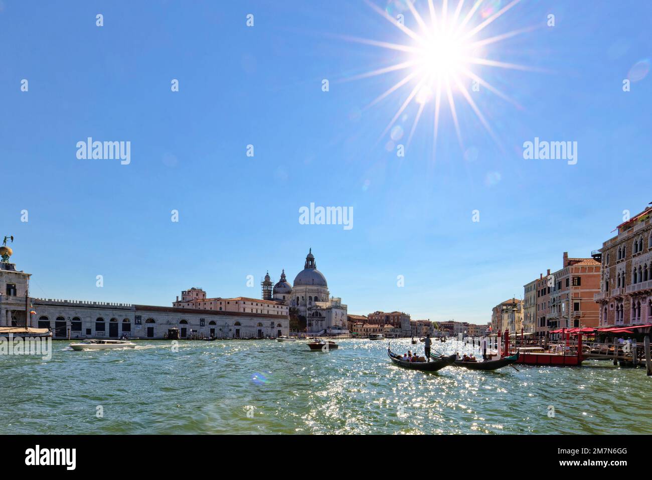 Gondolas take tourists on the Grand Canal in Venice past houses ...