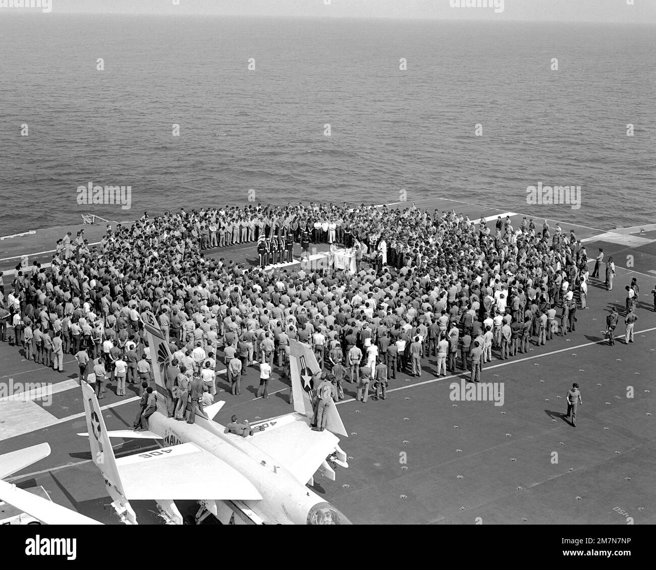 An overhead view of a memorial service on the flight deck of the ...