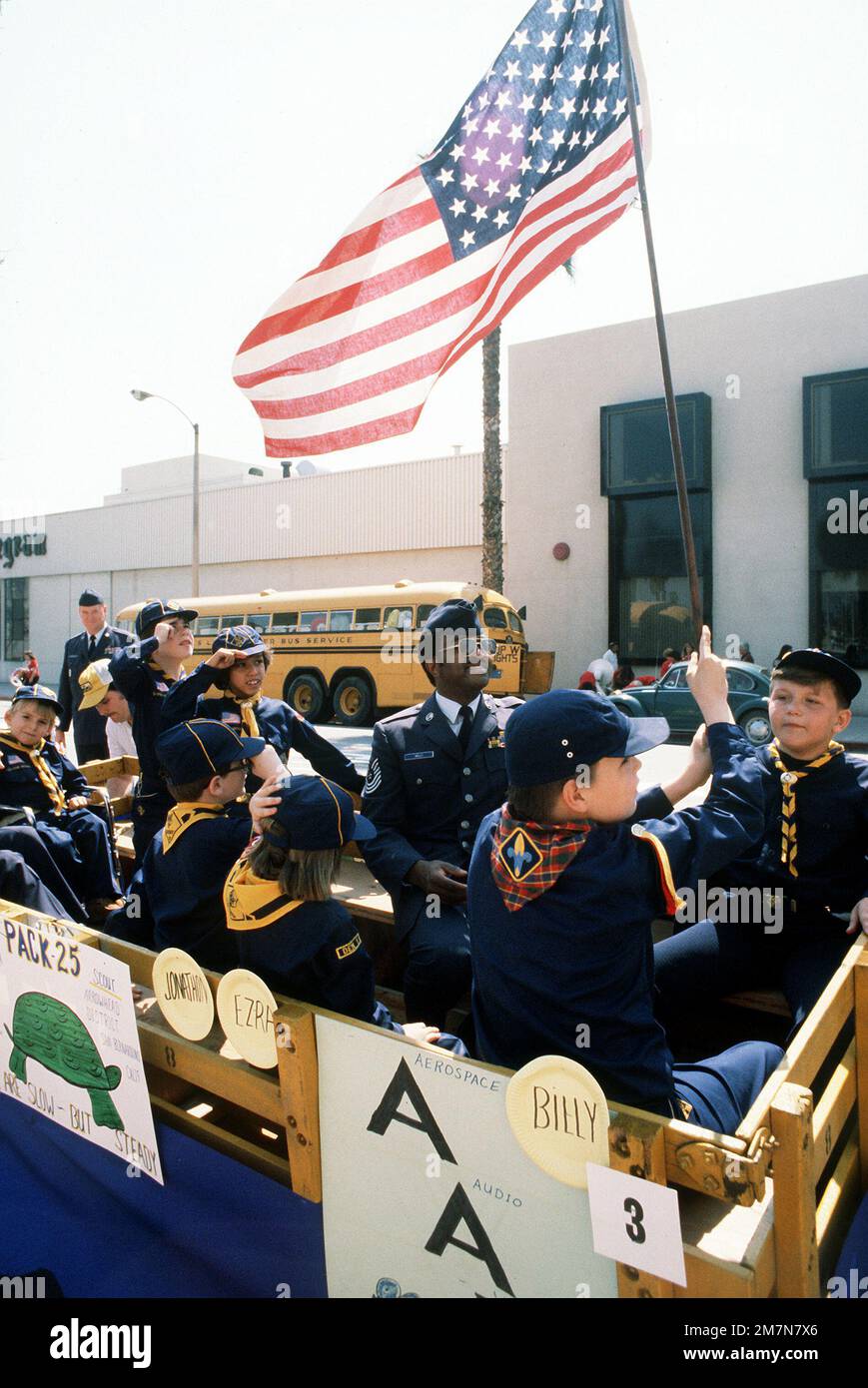 Cub Scout Billy Parnell raises the American flag while members of the ...