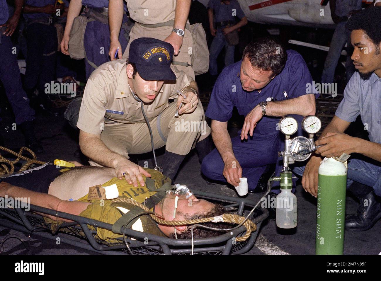 Lieutenant Commander James A. Gessler, senior medical officer, comforts ...