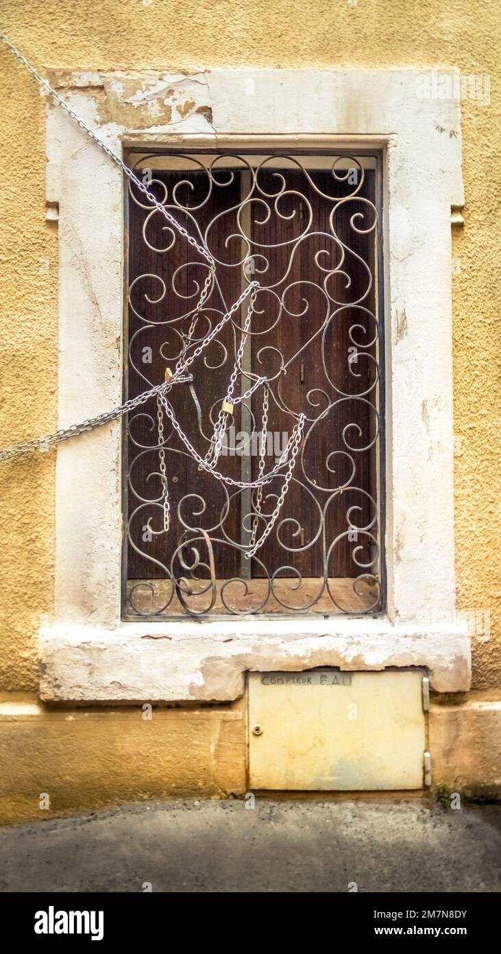 Chains on the window in Narbonne Stock Photo - Alamy