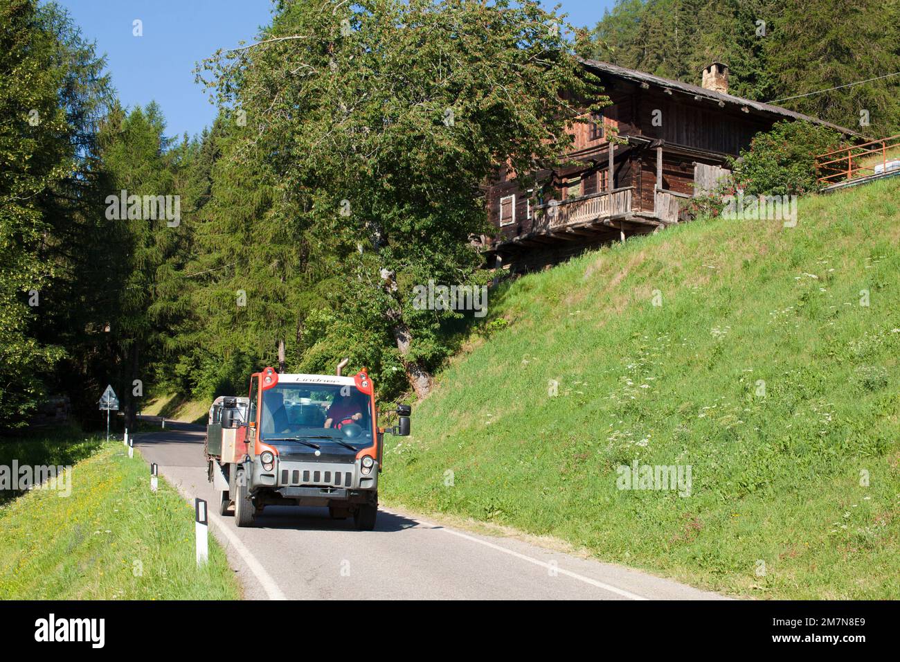 Vehicle on narrow road in front of South Tyrolean farm in Ulten Valley ...