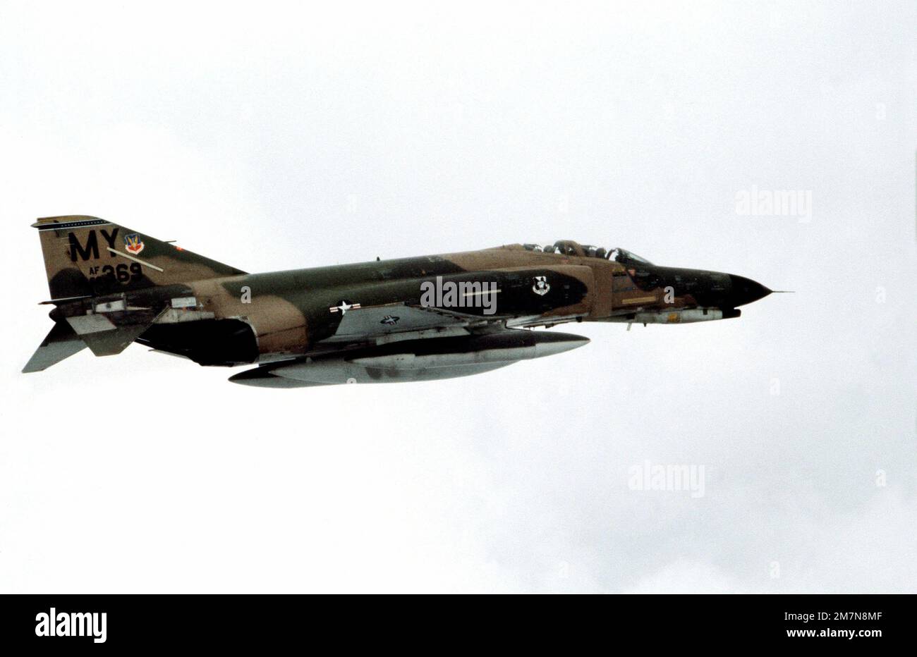 An air-to-air right side view of an F-4E Phantom II aircraft from the ...