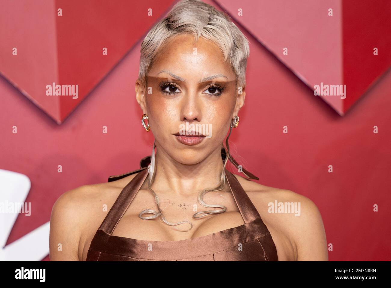 Poppy Ajudha poses for photographers upon arrival at the British ...