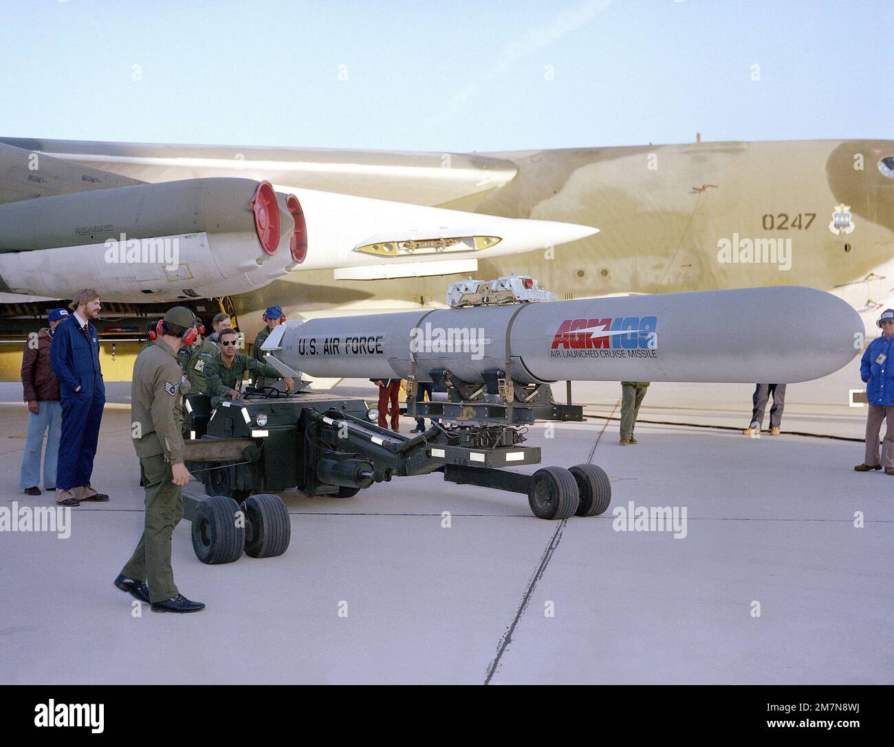 AN AGM-109 Tomahawk air-launched cruise missile is unloaded from a B-52 ...