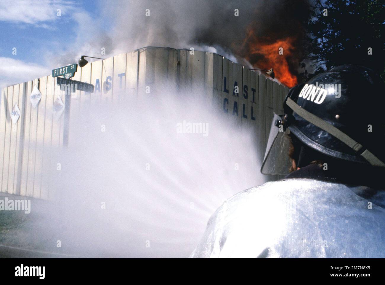An airman from Vandenberg Air Force Base uses a fog spray on a ...