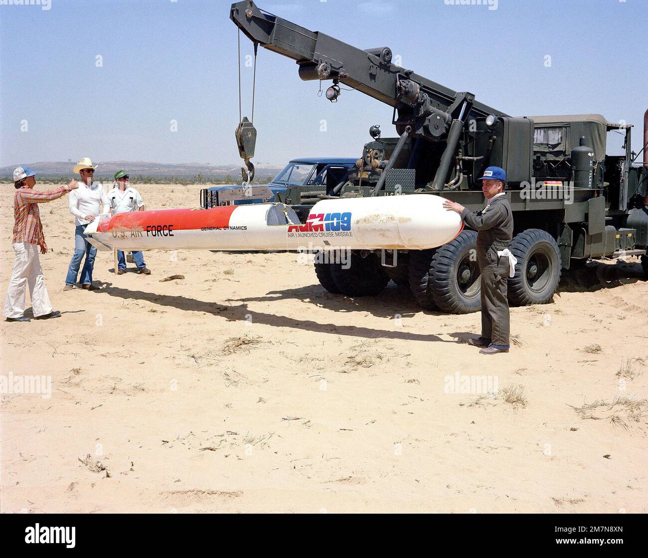 A crew uses a wrecker truck to lift an AGM-109 Tomahawk air-launched ...