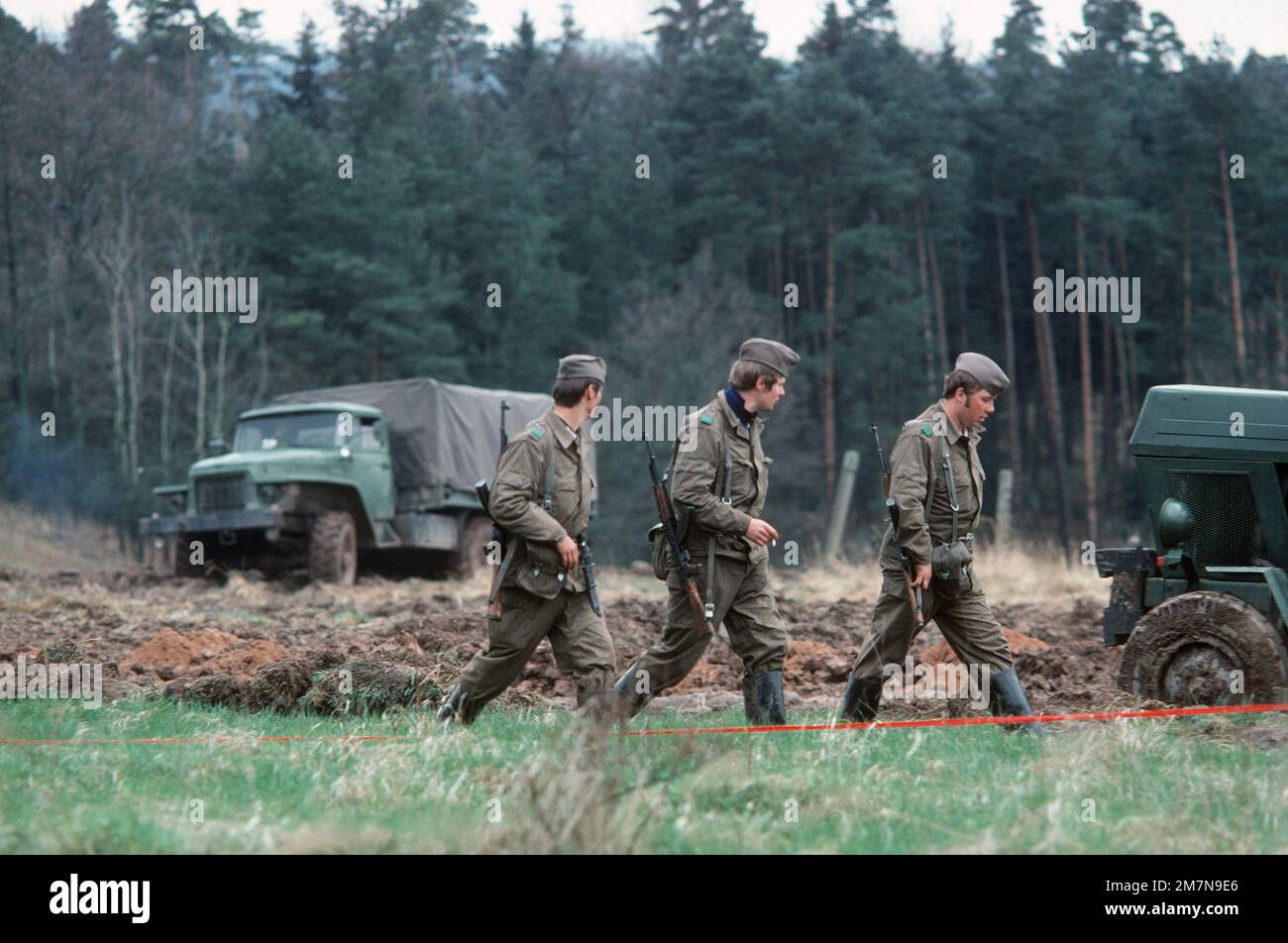 East German soldiers patrol the border between East and West Germany ...