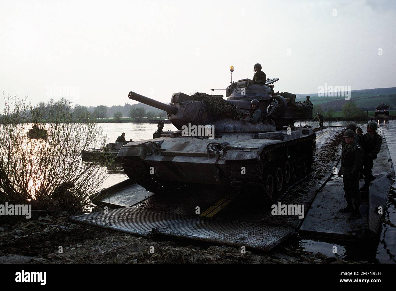An M-60A2 main battle tank rolls off a floating bridge. Country ...