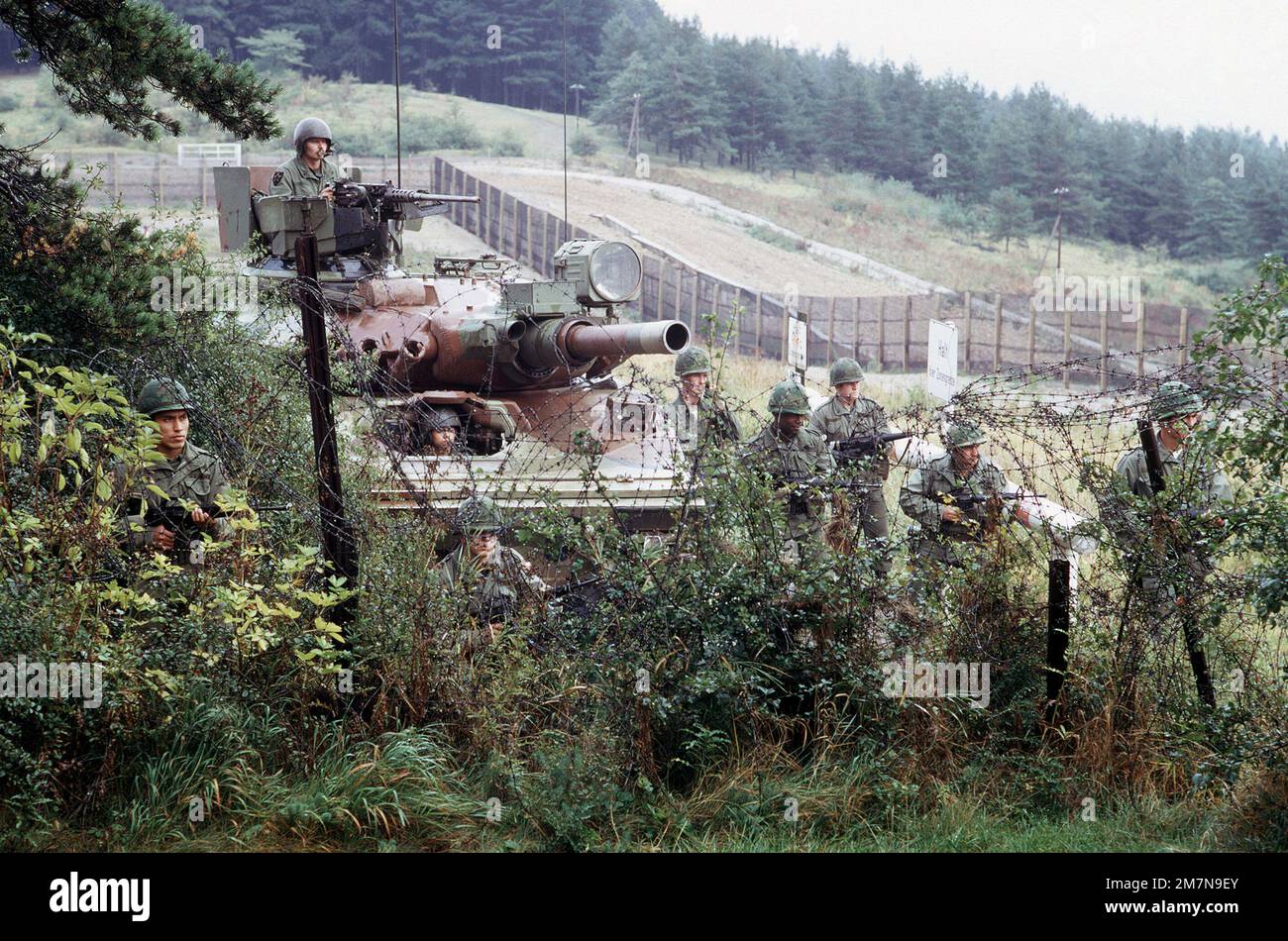 Members of the 11th Armored Cavalry deploy around an M551 Sheridan ...